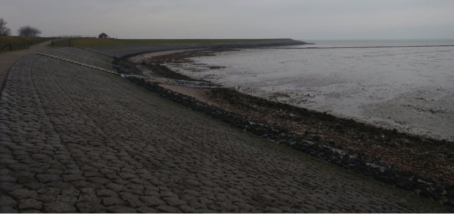 Armored sea dike in the Netherlands at low tide.