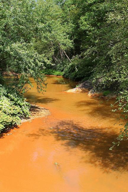 Orange coal mine drainage into a creek
