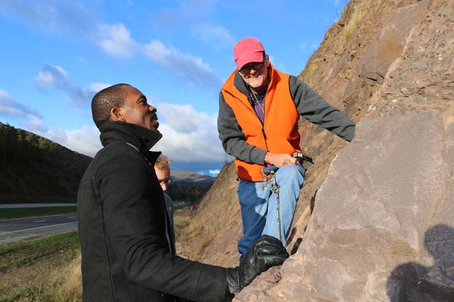 Geologists examine rocks
